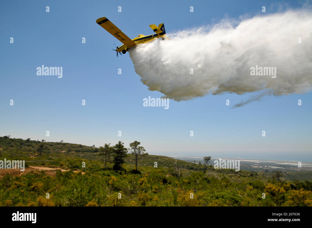 firefighting Aircraft dropping fire retardant on a fire during a ...