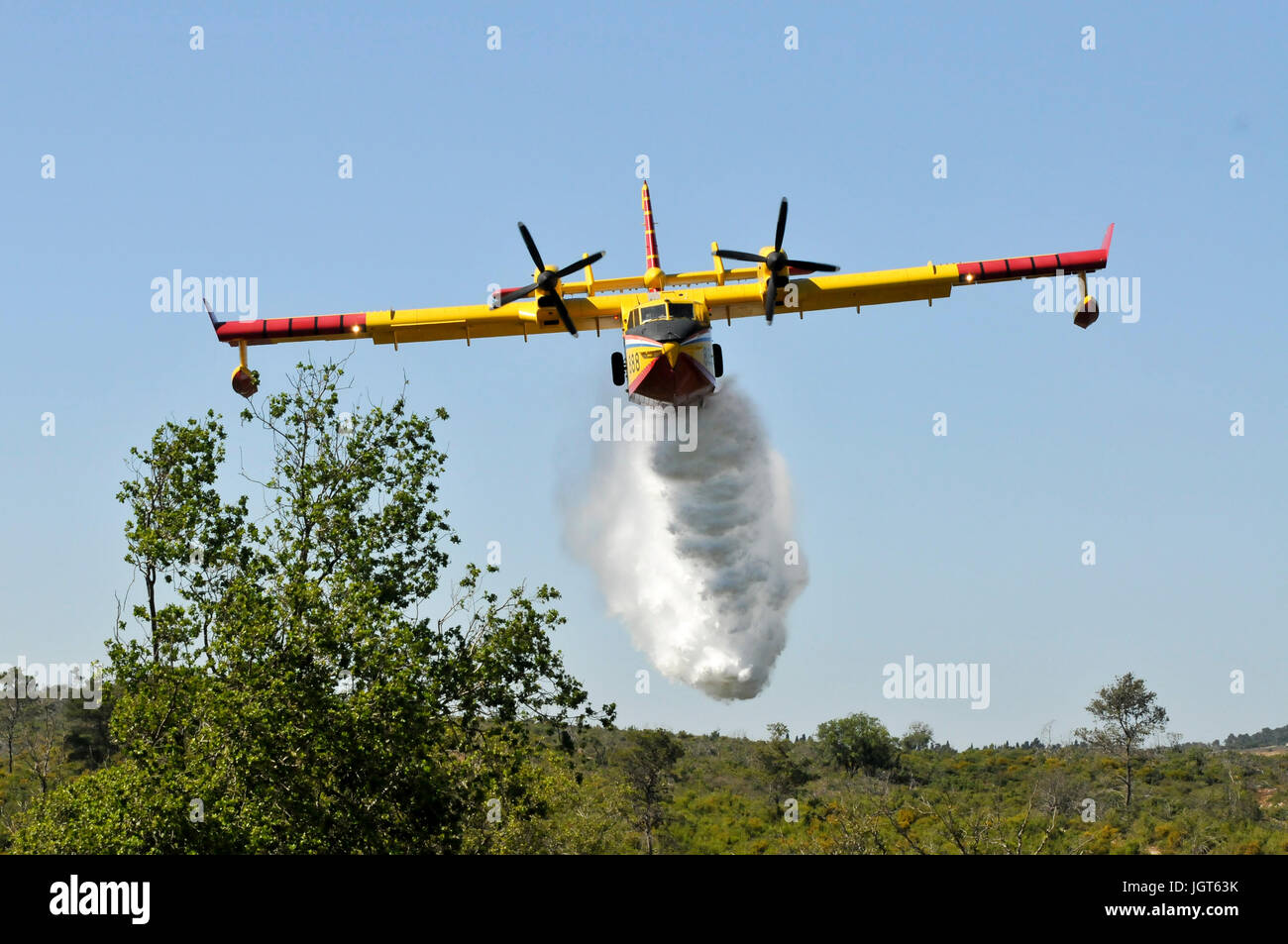 firefighting Aircraft dropping fire retardant on a fire during a ...