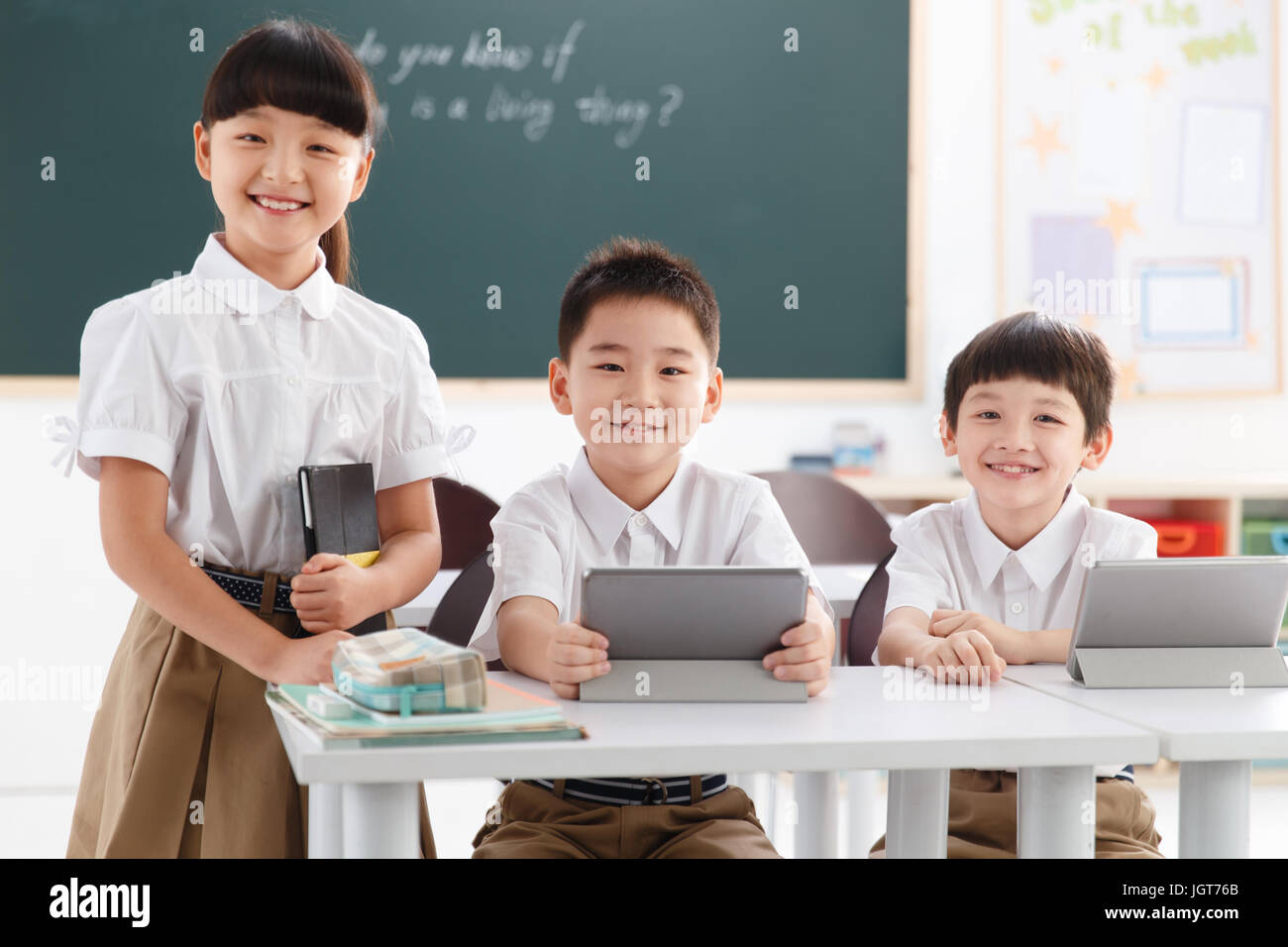 Students using digital tablet in classroom Stock Photo - Alamy