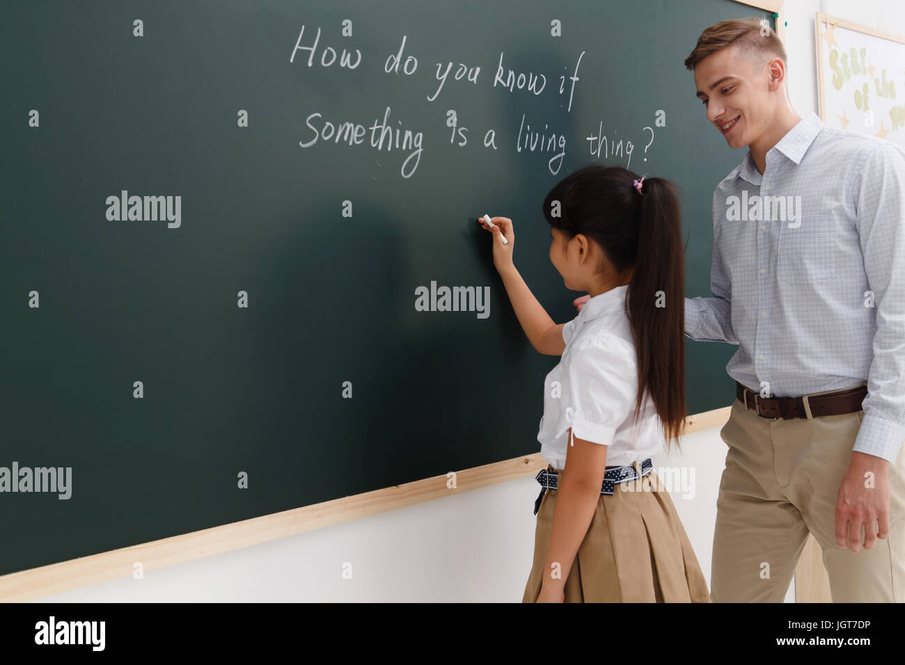 Male teacher with students in classroom hi-res stock photography and ...