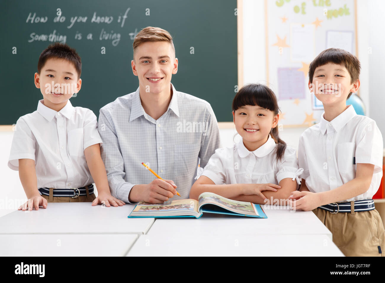 Portrait of students with male teacher Stock Photo - Alamy