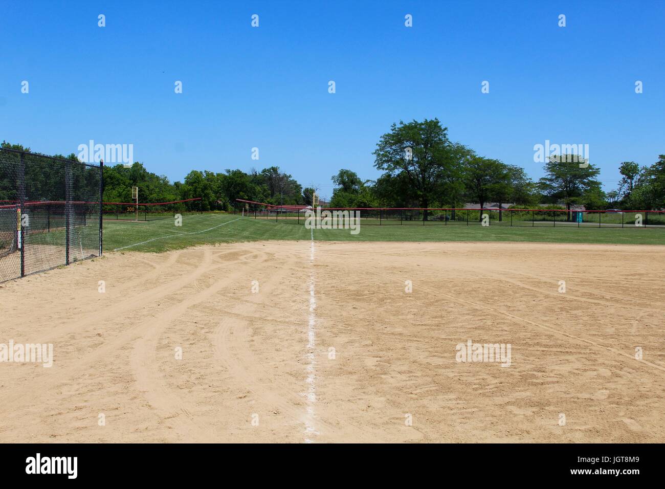 The baseball field and the lakes of the park on a sunny afternoon day ...