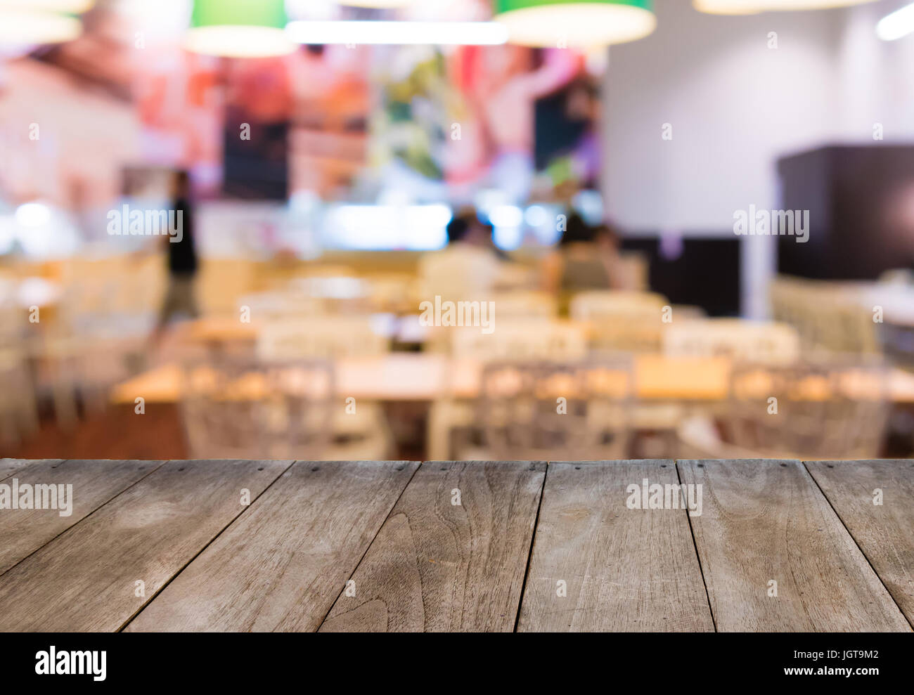 Perspective of empty wooden table in front of blurred background of ...