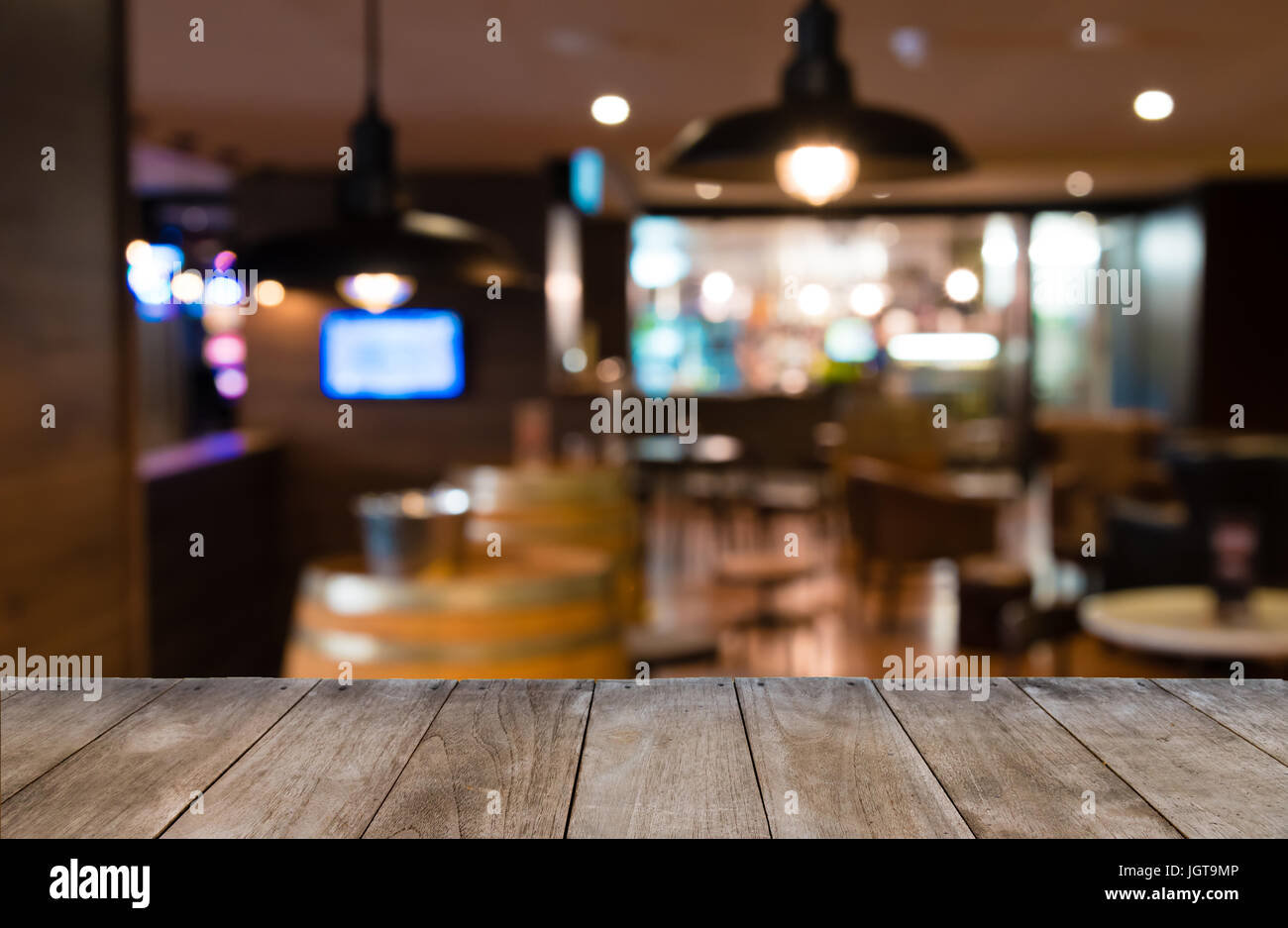 Perspective of empty wooden table in front of blurred background of ...