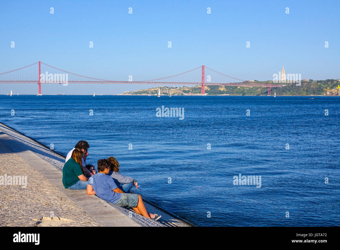 Relaxing at beautiful Tagus River in Lisbon aka Tejo Stock Photo - Alamy