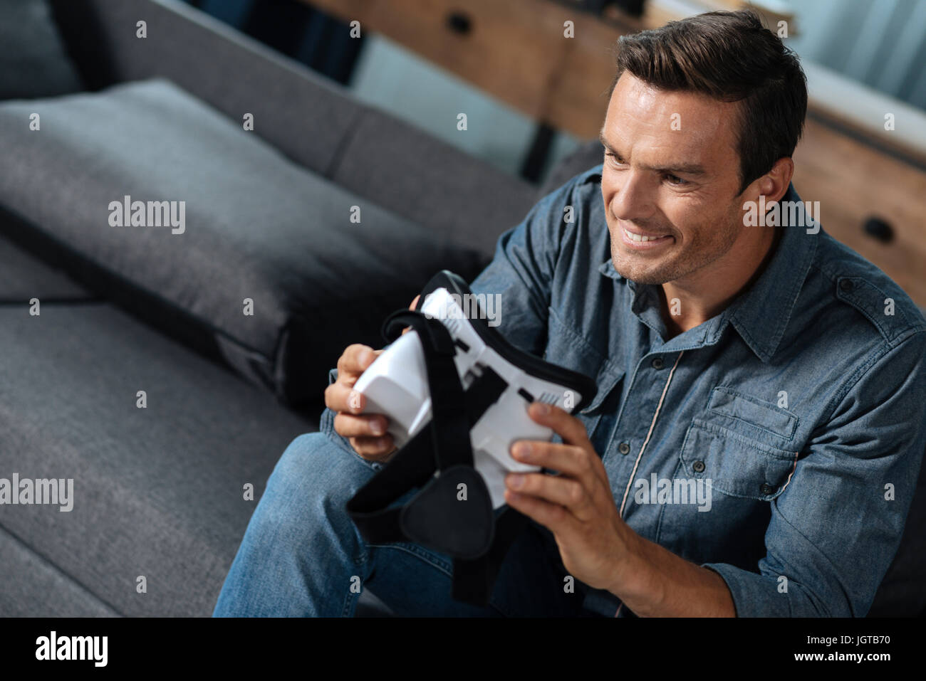 Enthusiastic progressive man setting up the device Stock Photo - Alamy