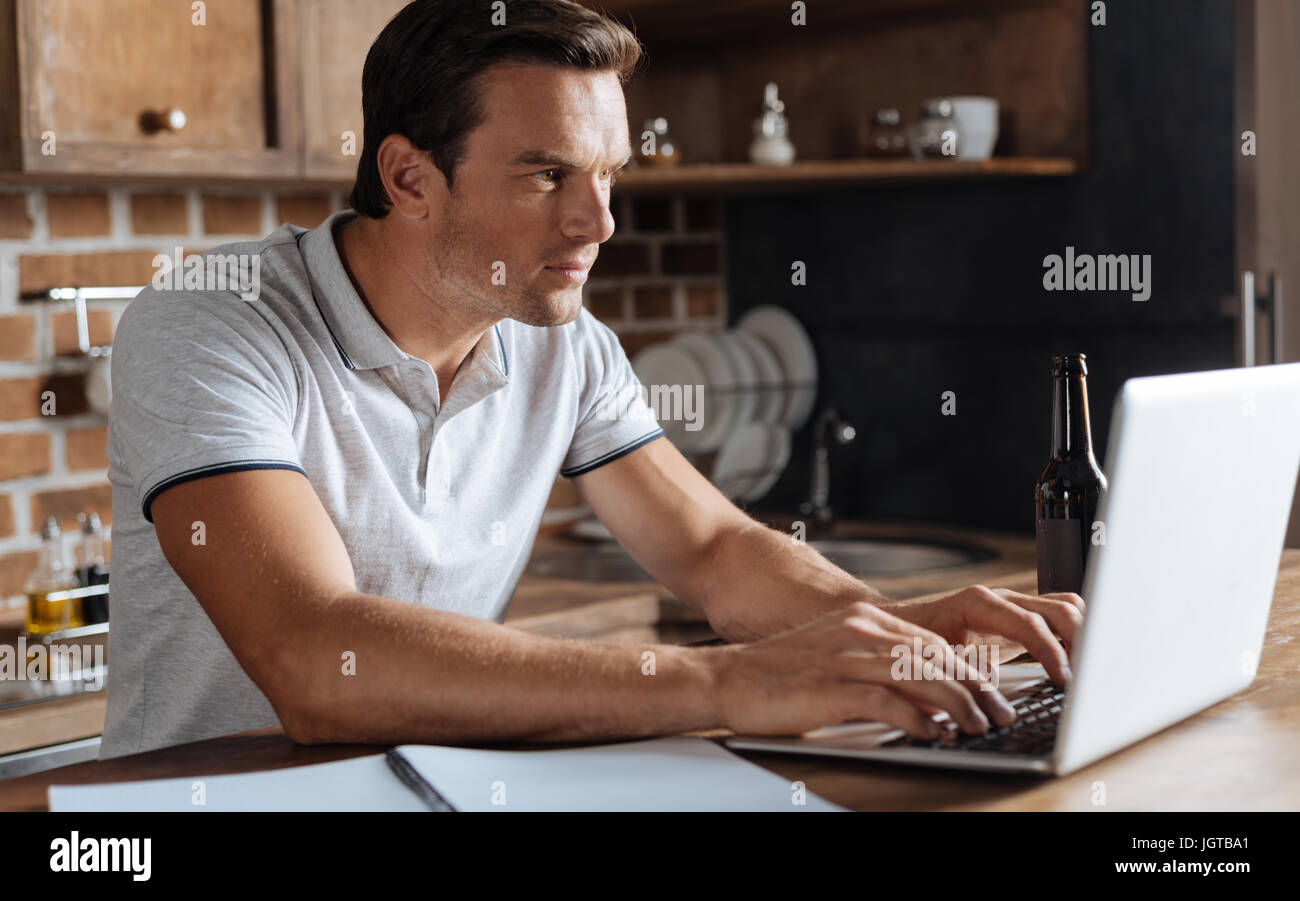 Positive intelligent guy working in the kitchen Stock Photo - Alamy