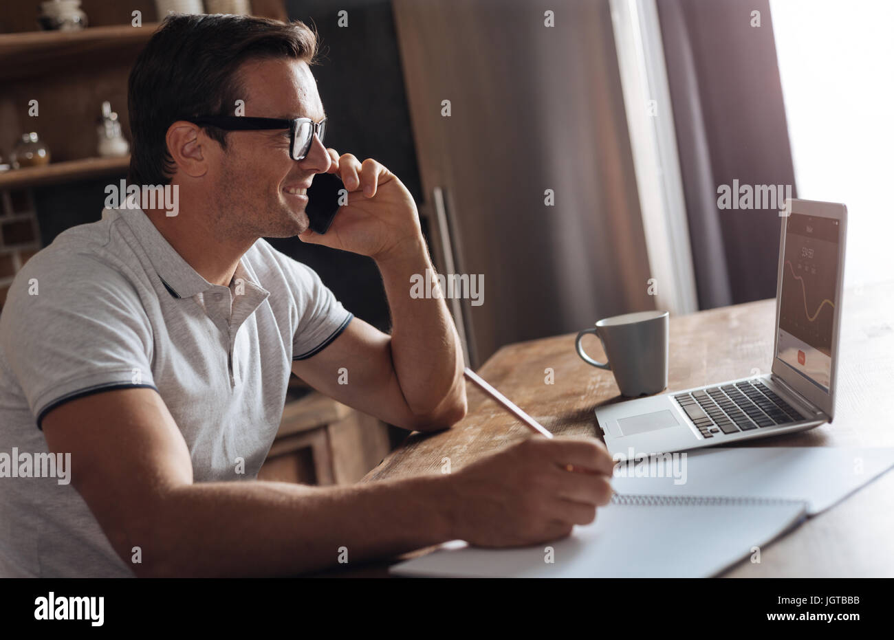 Friendly intelligent man calling his employer Stock Photo - Alamy