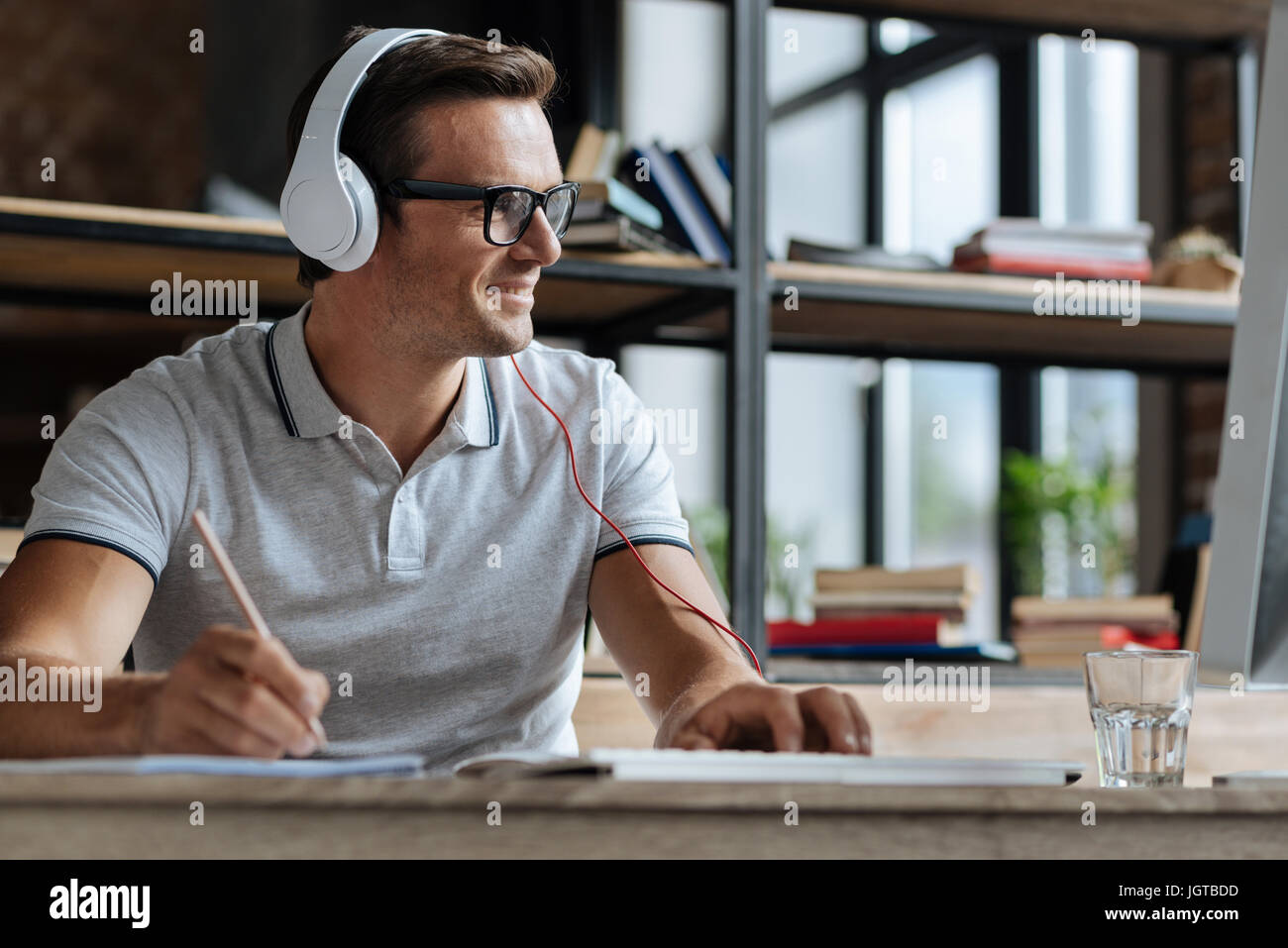 Charming talented guy performing data analysis Stock Photo - Alamy