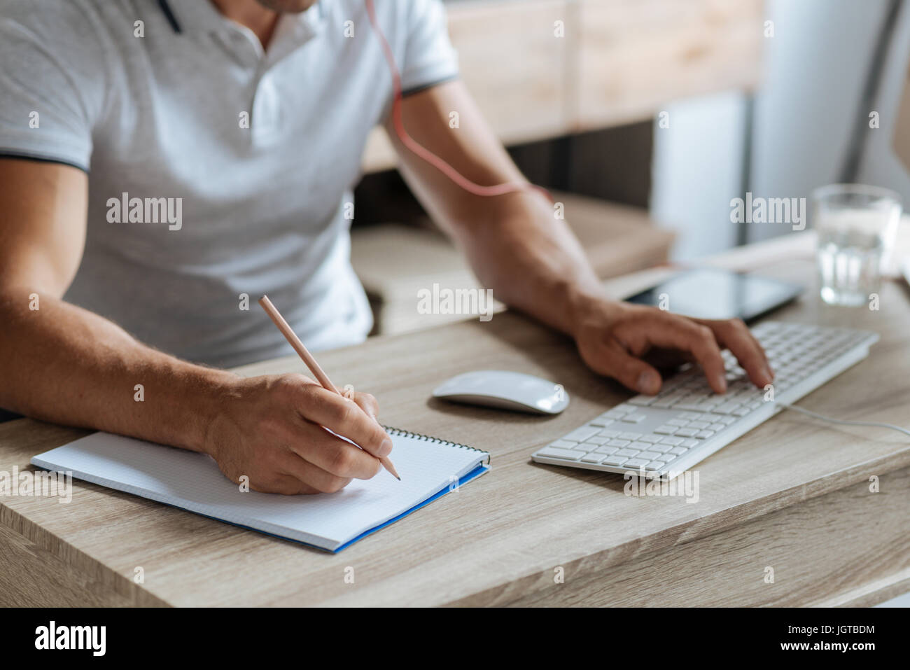 Committed productive man busy working Stock Photo - Alamy