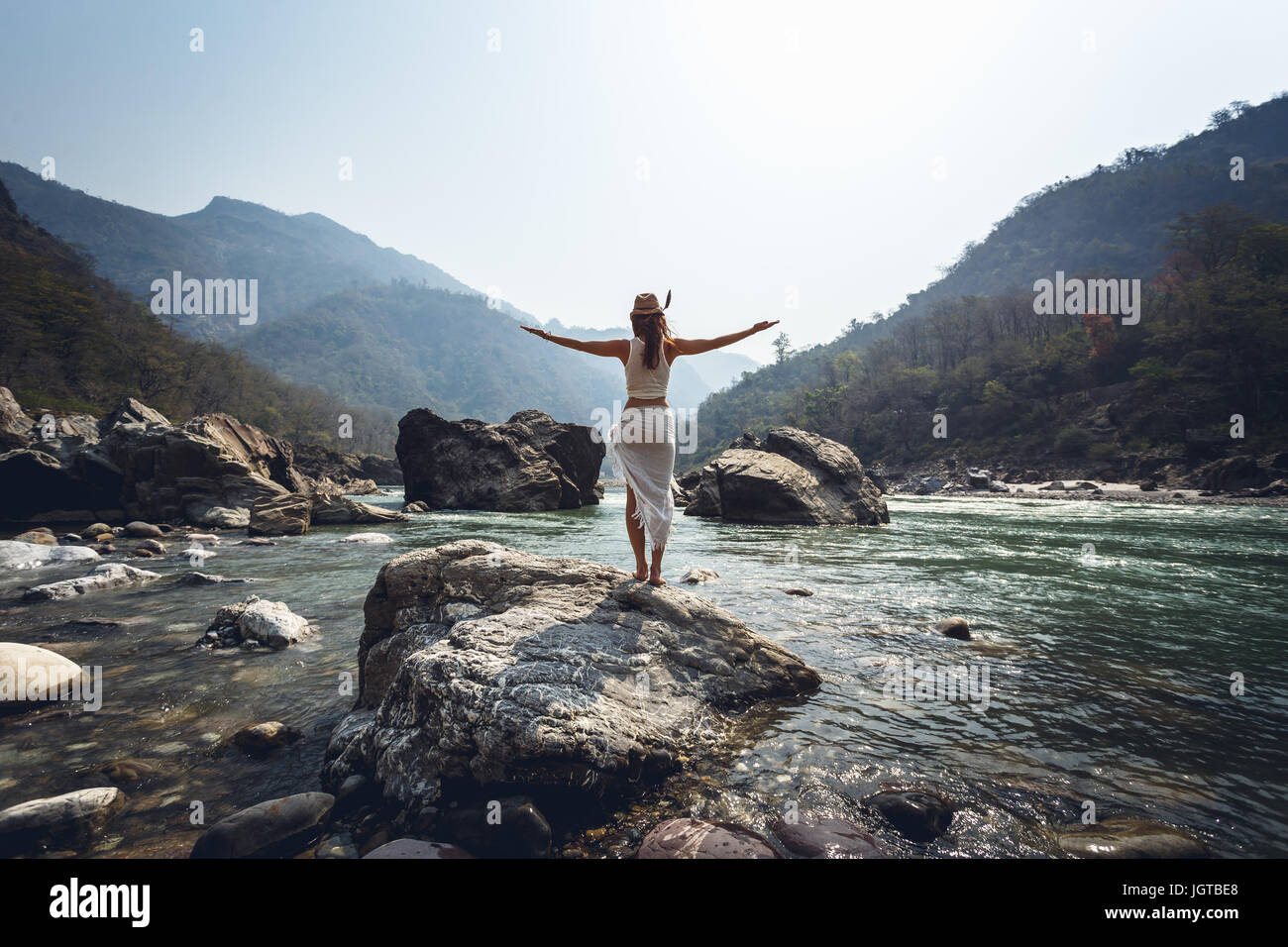 Beautiful woman rise up her hands like wings in greeting nature ...