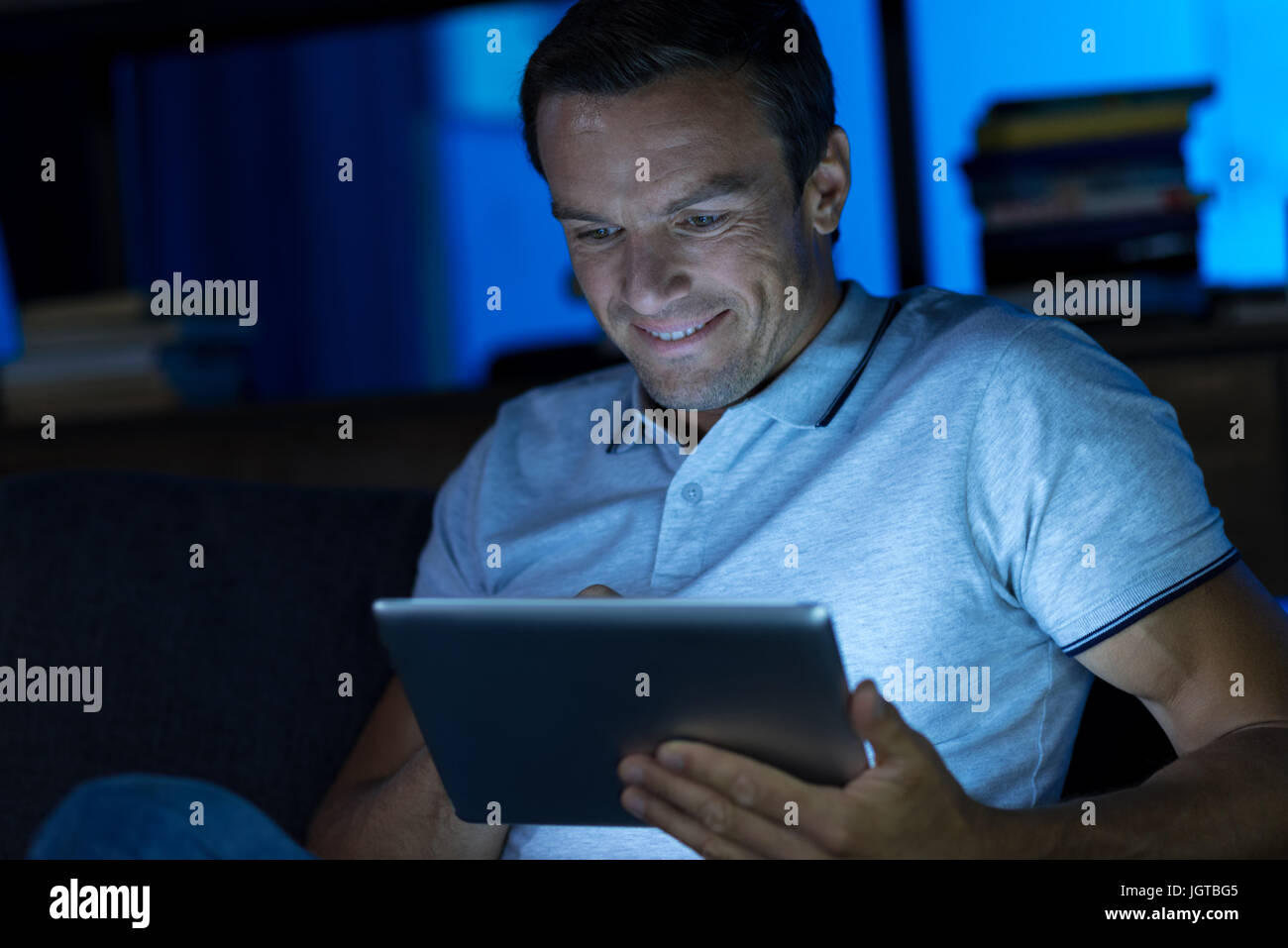 Enthusiastic passionate man reading something online Stock Photo - Alamy