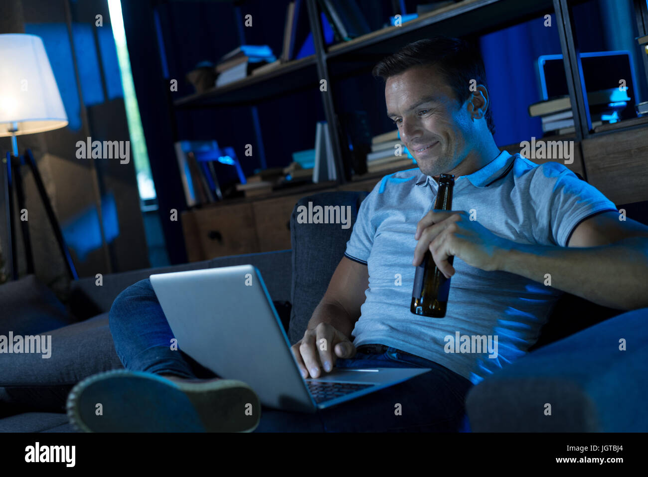 Friendly easy going guy scrolling through the newsfeed Stock Photo - Alamy