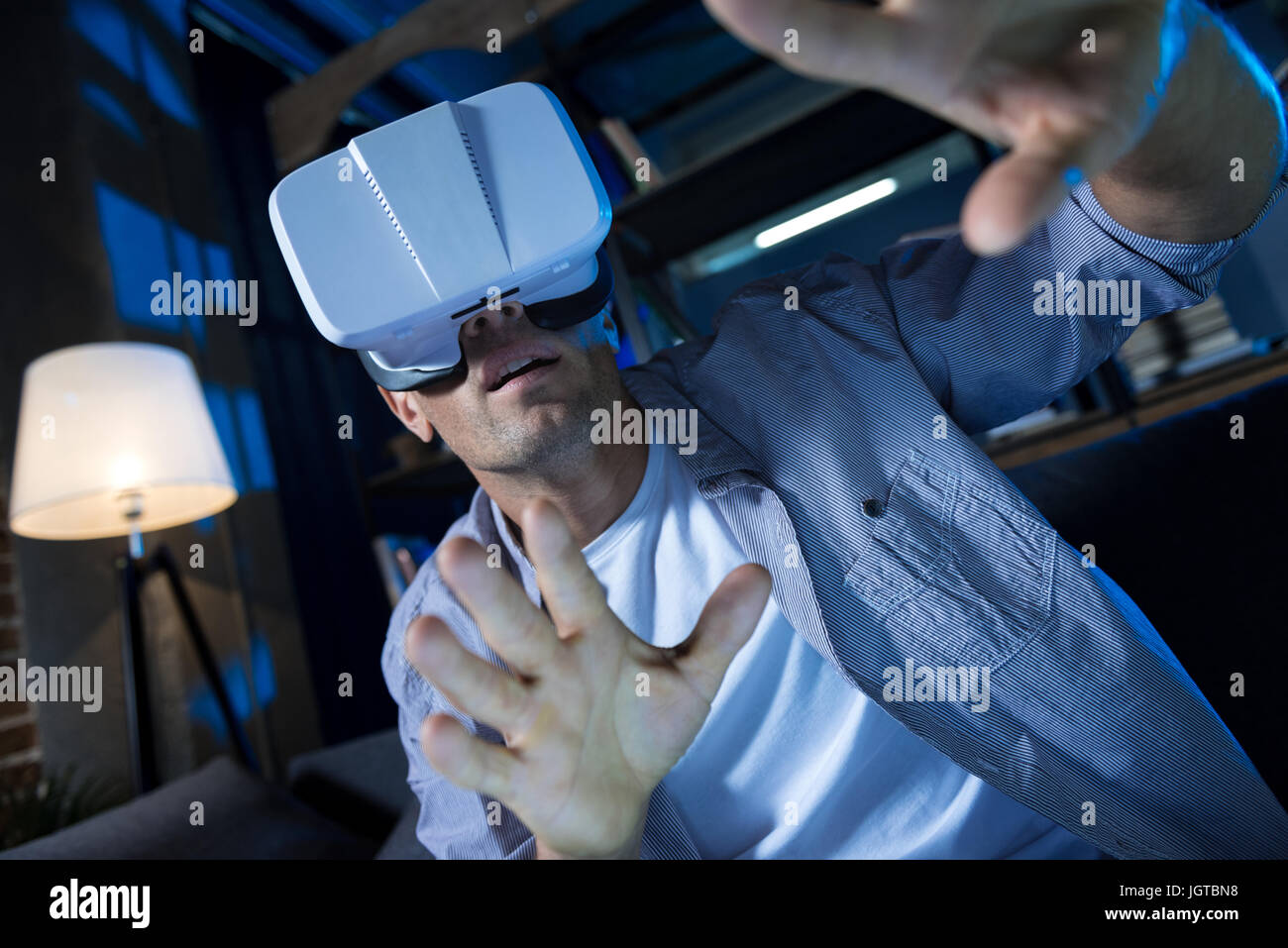 Inventive devoted man exploring new dimensions of technology Stock ...