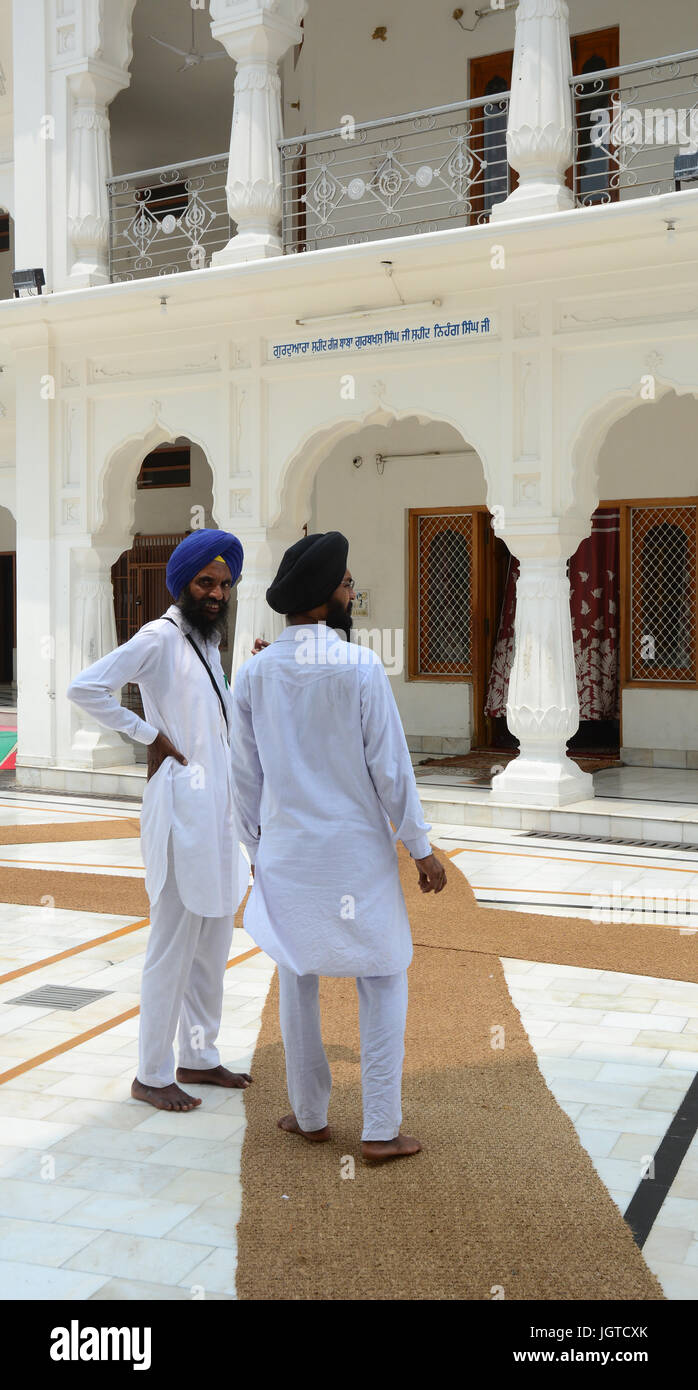 Amritsar, India - Jul 25, 2015. Sikh guards standing at the Golden ...