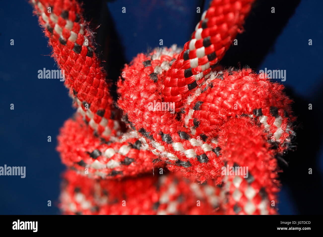 red and white colored rope with knot Stock Photo - Alamy