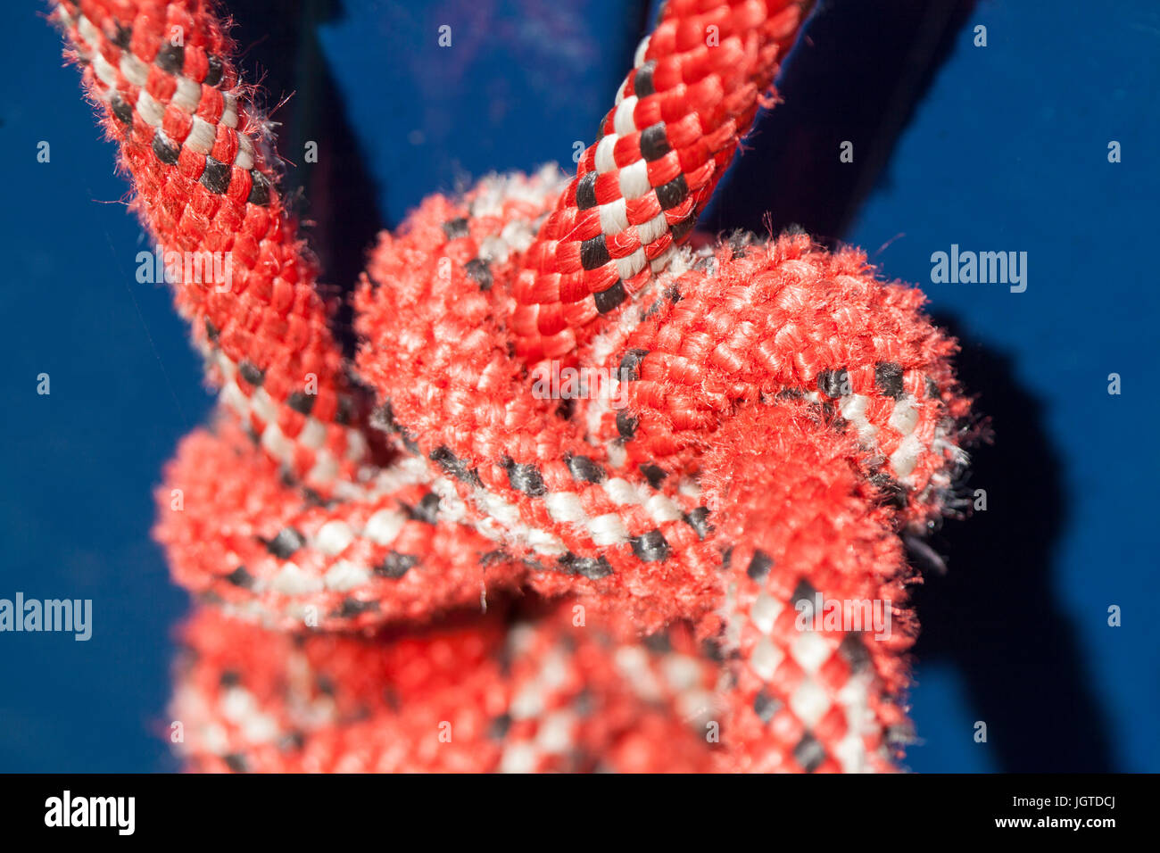 red and white colored rope with knot Stock Photo - Alamy