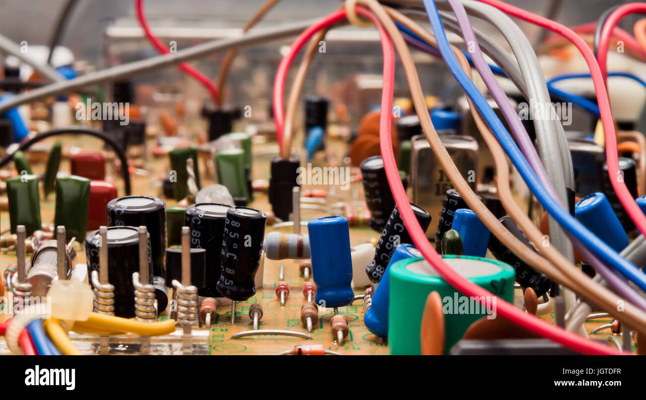 Close up of a circuit board with electrical components and colored ...