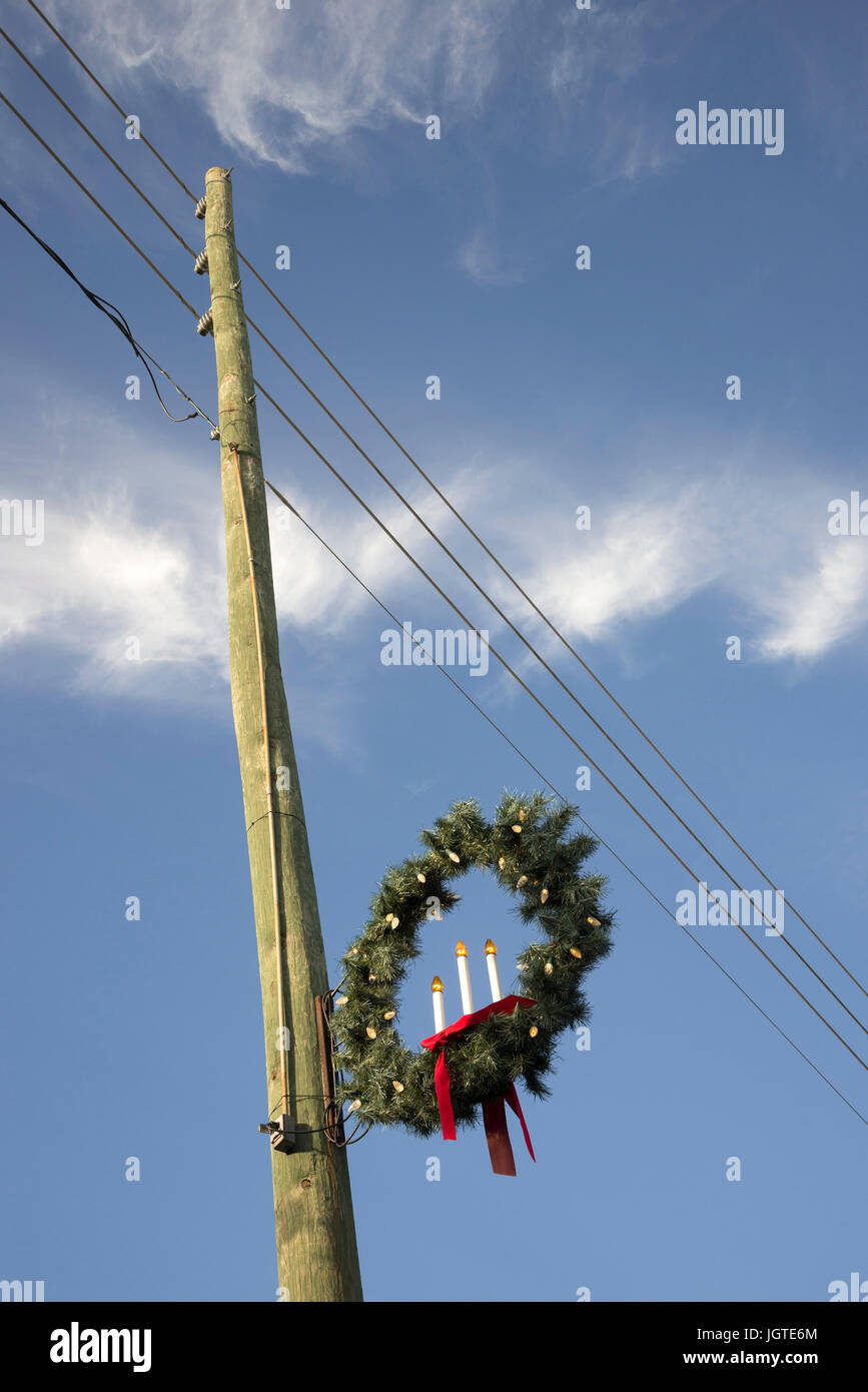 Christmas wreath decoration hangs from a power pole along main street ...