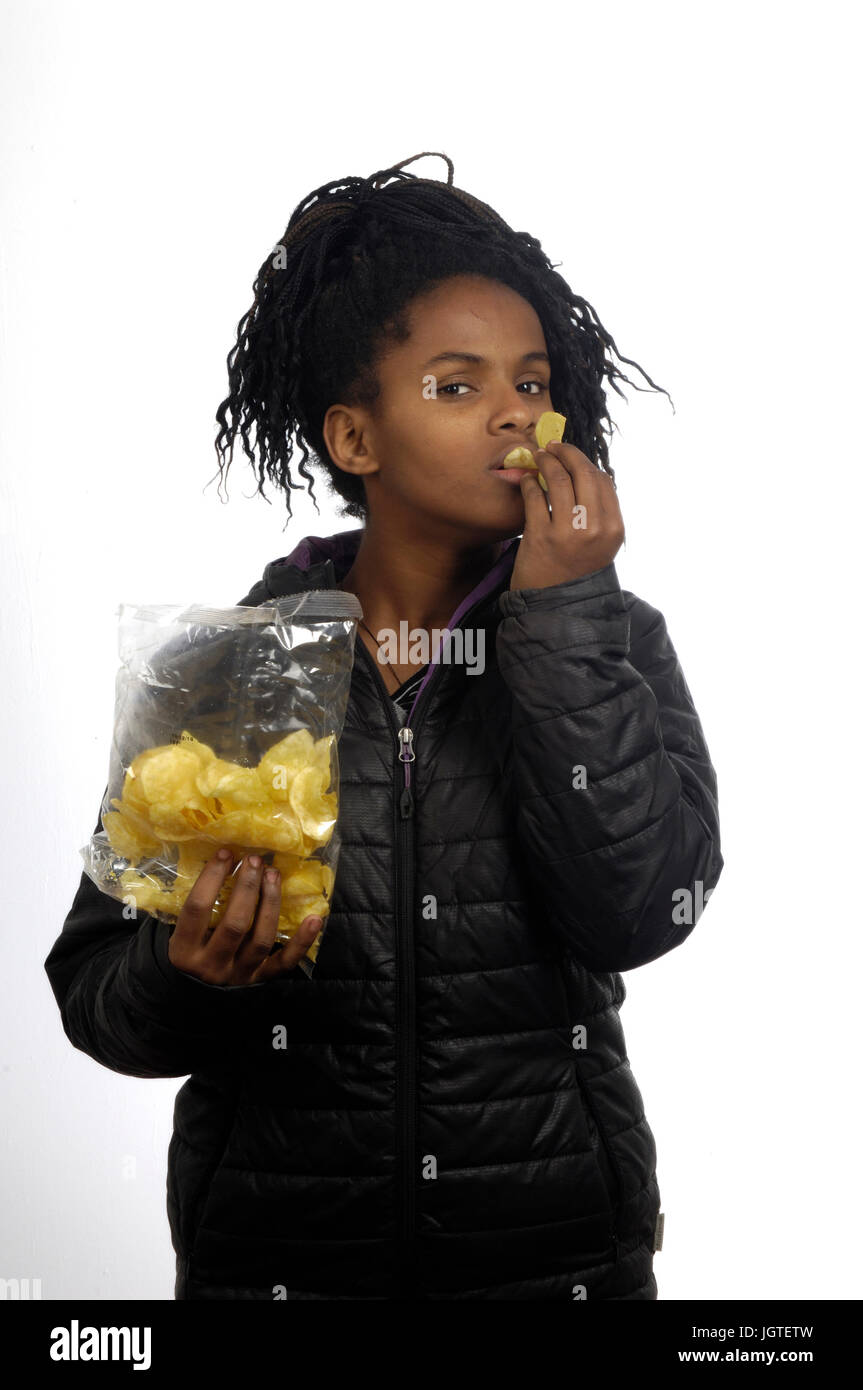 teenage girl eating chips Stock Photo - Alamy