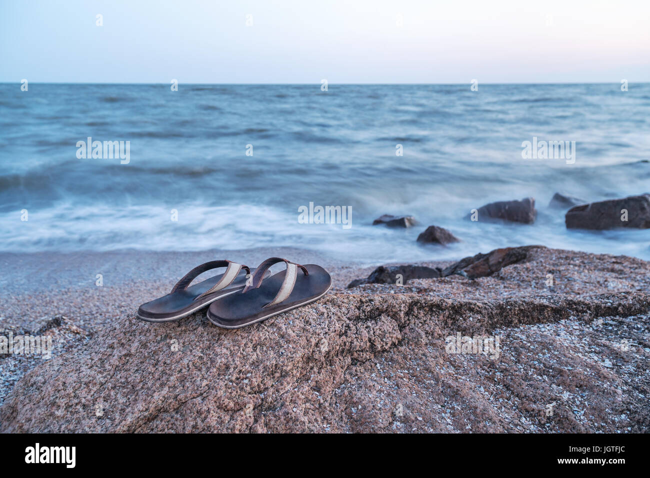 Flip flops on the beach Stock Photo - Alamy