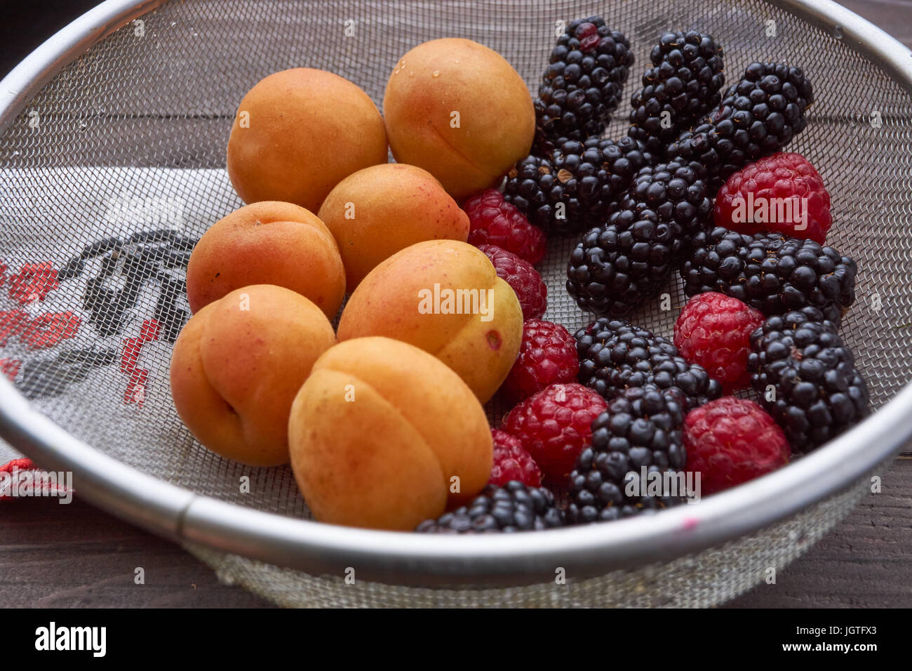 colander grid with the washed red black berries raspberry blackberry ...