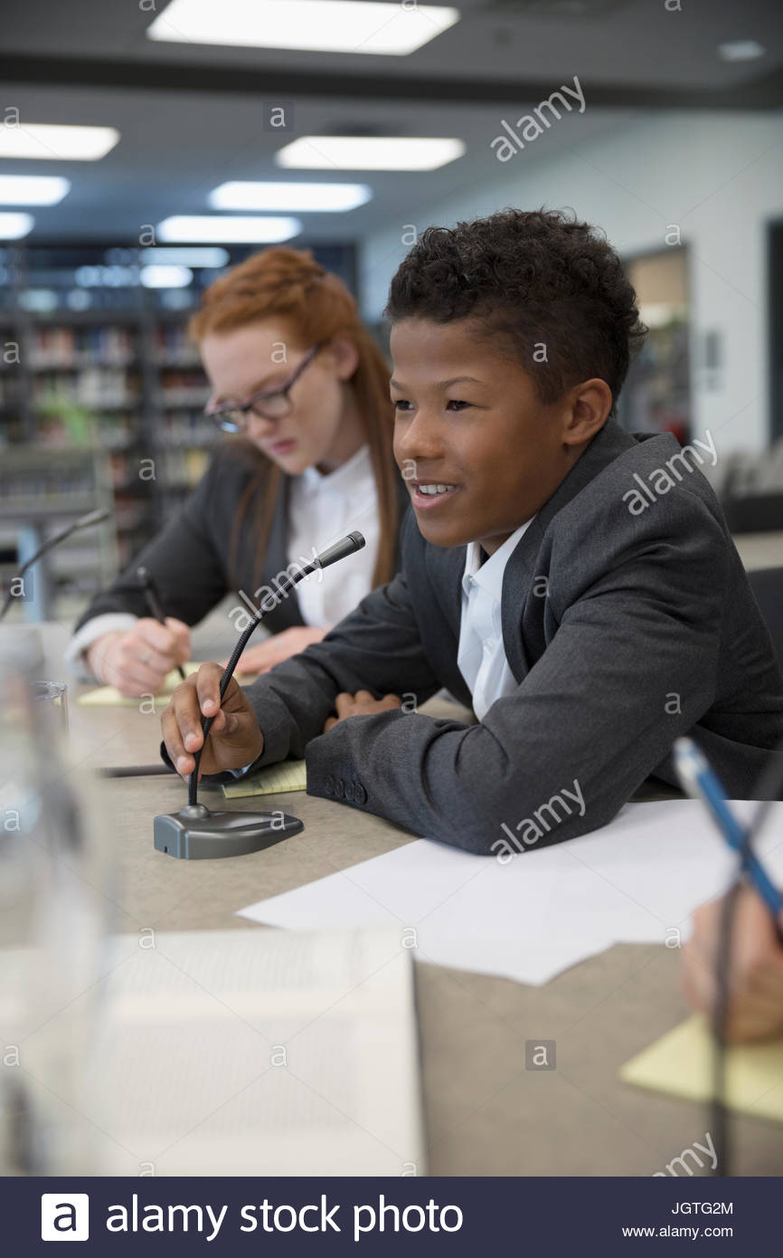 Microphone sitting looking away communication holding hi-res stock ...