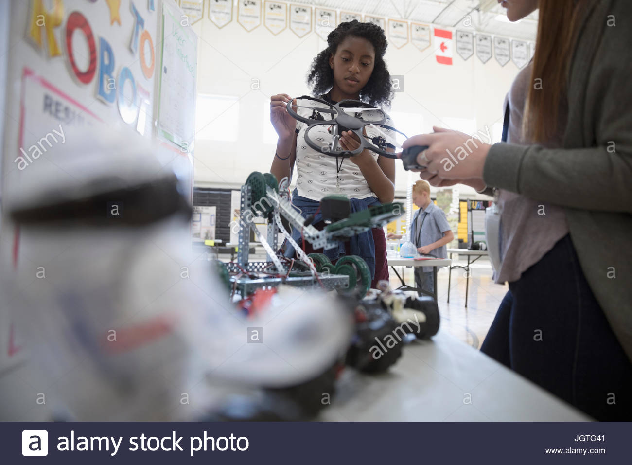 Girl middle school student examining robot at science fair Stock Photo ...