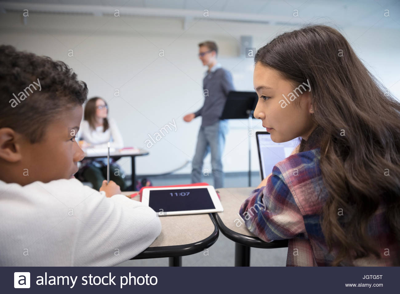 Middle School Students Talking In Debate Club In Classroom Stock Photo middle-school-students-talking-in-debate-club-in-classroom-stock-photo