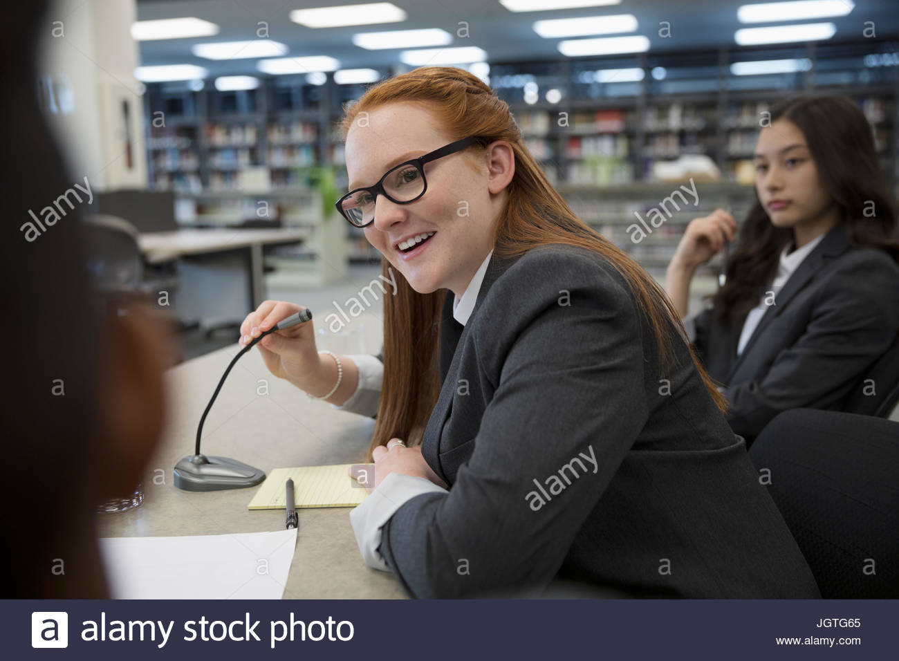 Smiling girl middle school student in debate club library Stock Photo ...
