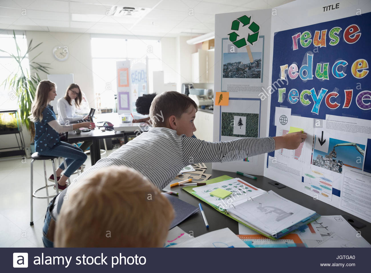 Boy middle school student working on recycling science project in ...