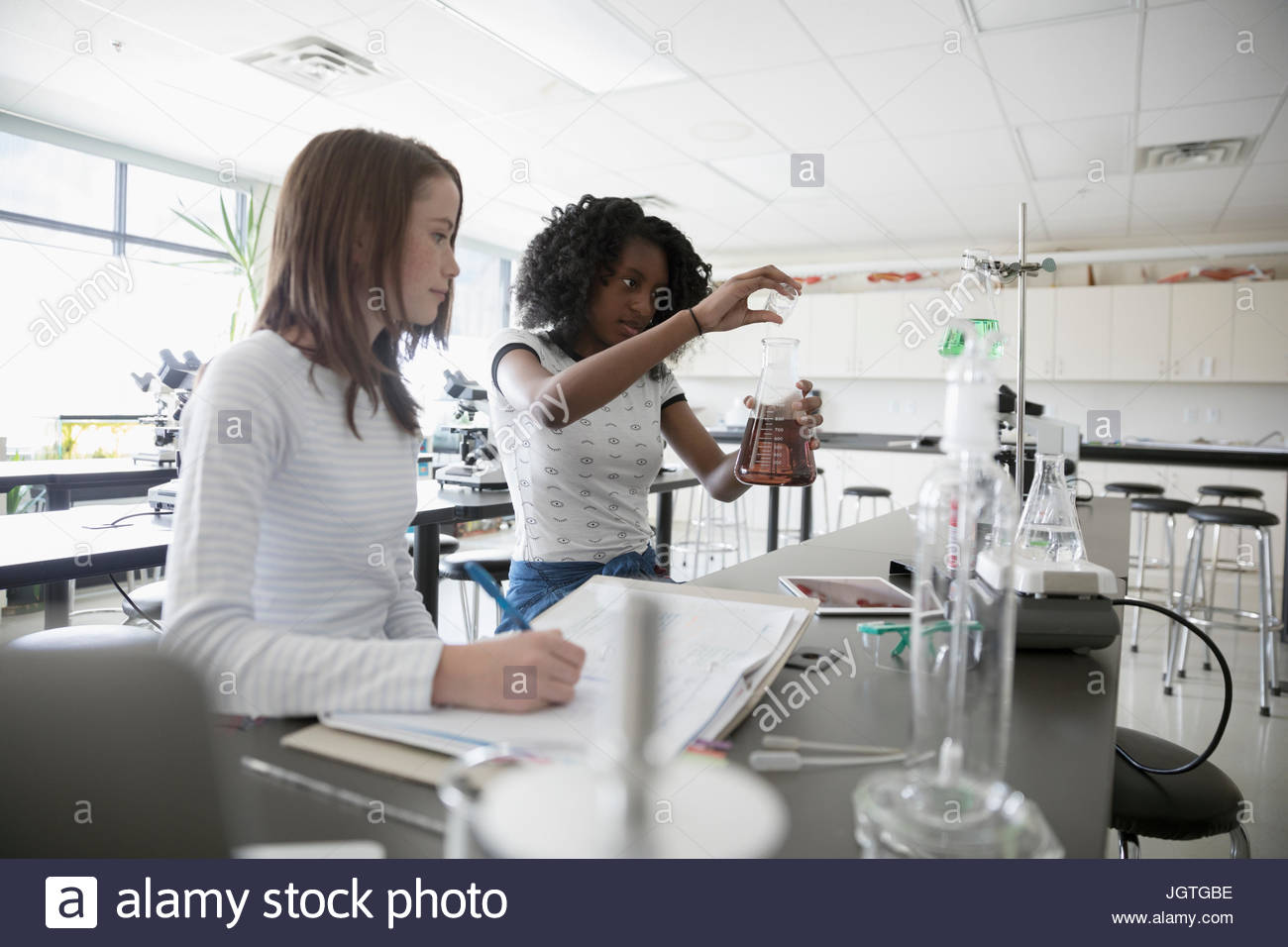 School girl conducting experiment in hi-res stock photography and ...