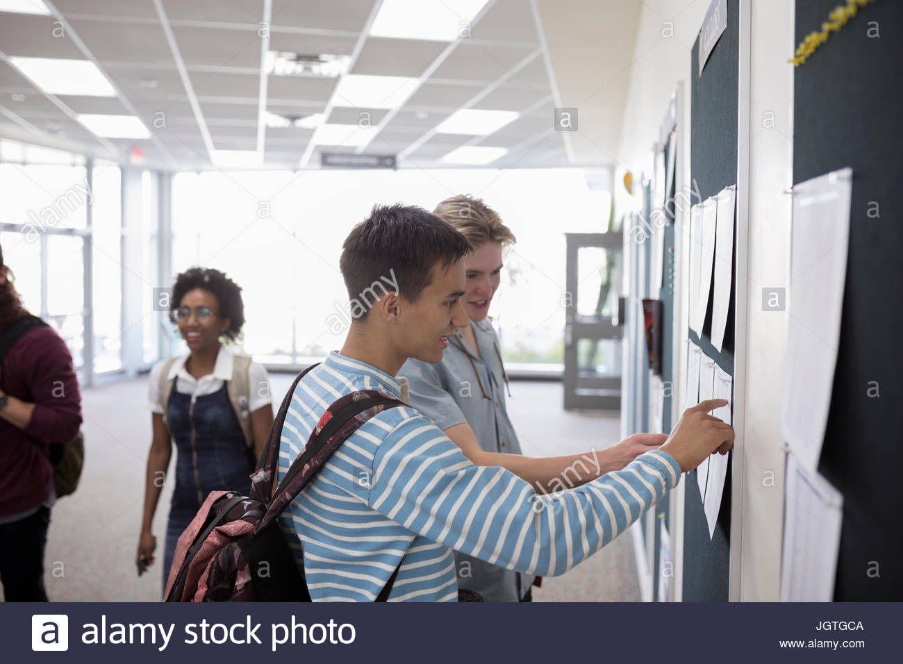 Two people looking at bulletin board hi-res stock photography and ...