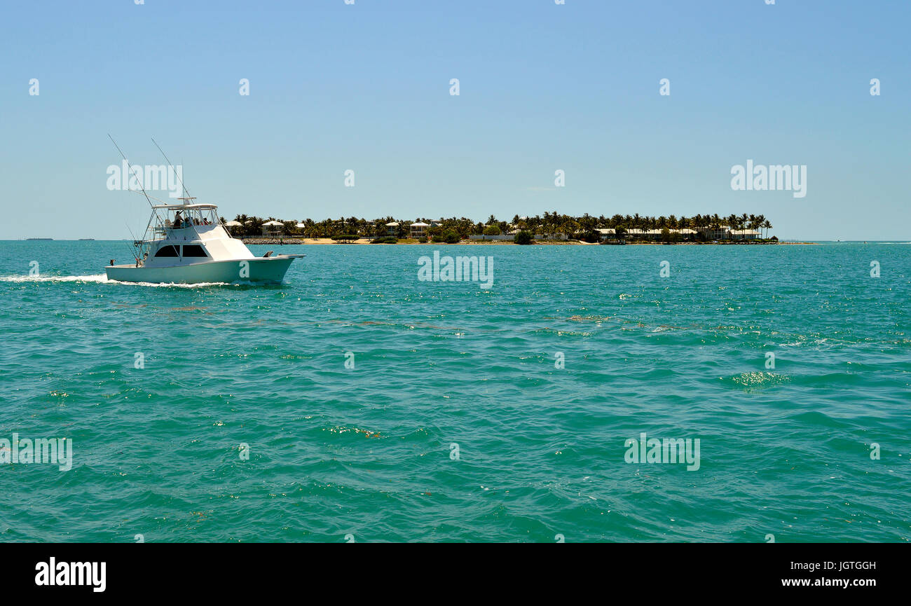 Fishing boat sailing past Sunset Key in Florida Stock Photo - Alamy