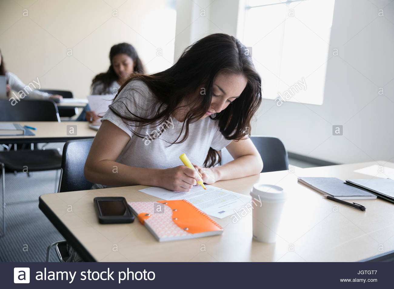 Focused female college student studying in classroom Stock Photo - Alamy
