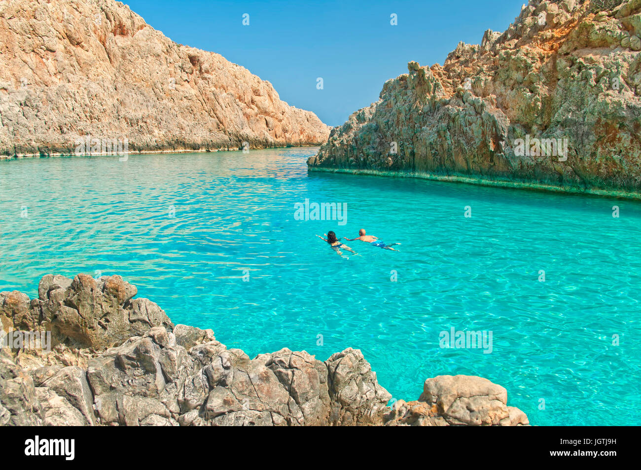 horizontal image of young caucasian couple swimming in turquoise ...