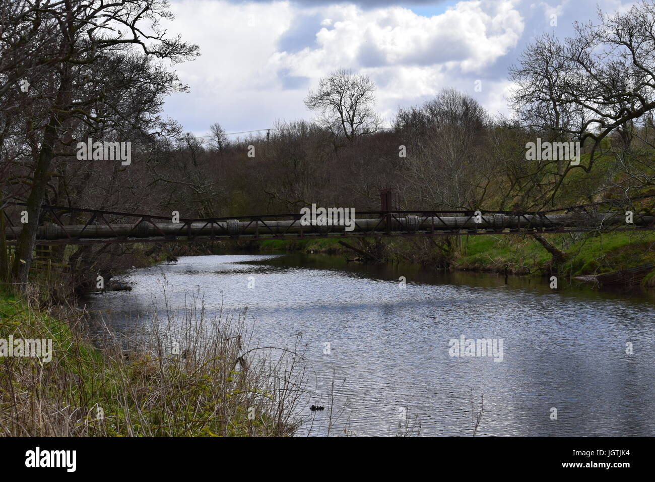 Pipe over a river Stock Photo - Alamy