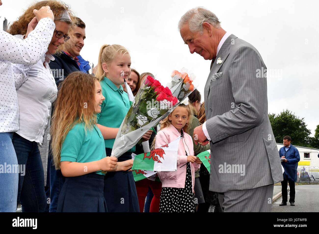 The Prince of Wales is greeted by local school children Francesca ...