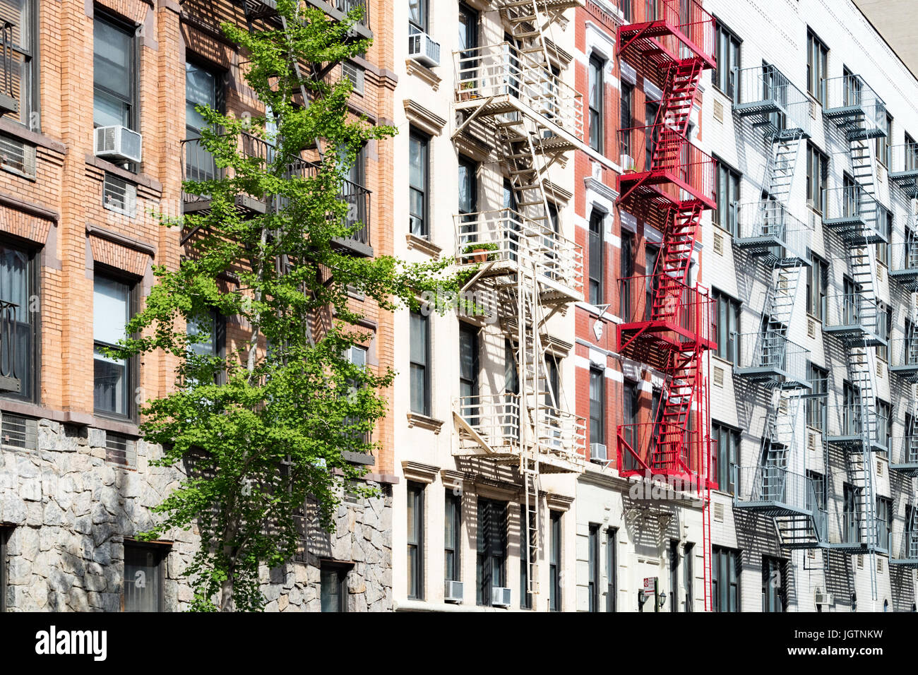 New York City street scene of a colorful block of apartment buildings ...