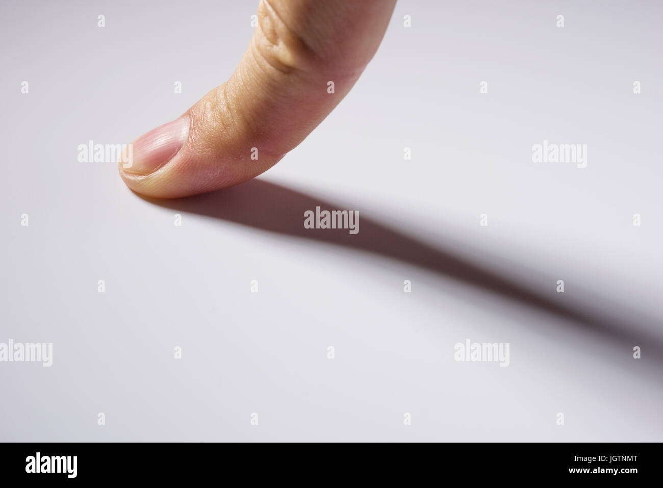 Finger with its shadow on white background Stock Photo - Alamy
