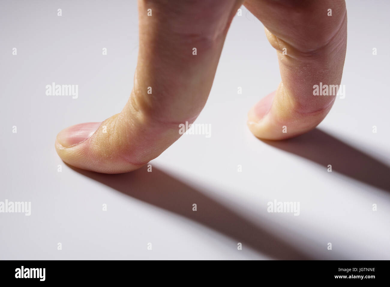 Two Fingers with its shadow on white background Stock Photo - Alamy