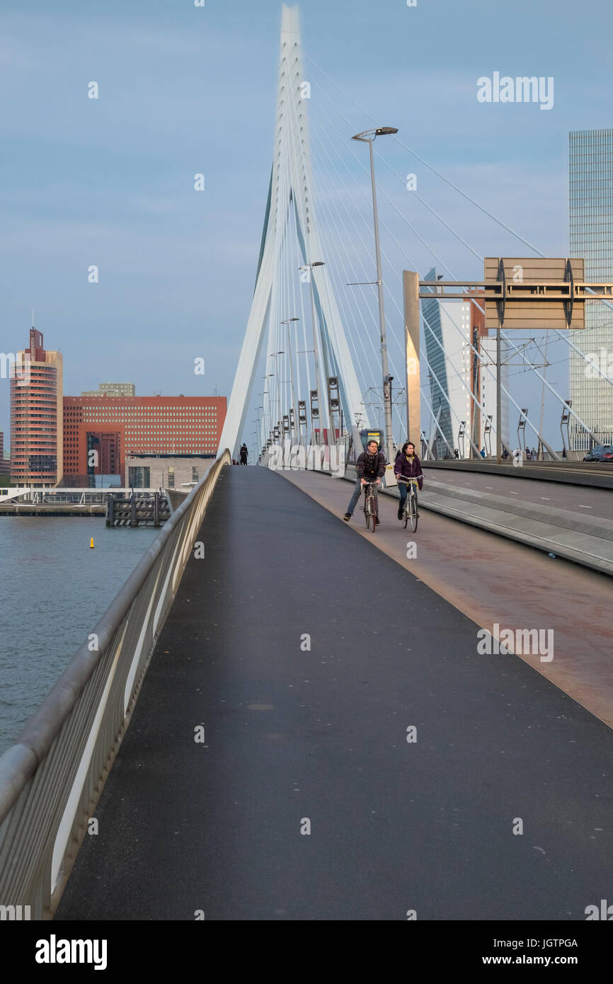 Cyclists travelling over Erasmus Bridge, Rotterdam, The Netherlands ...