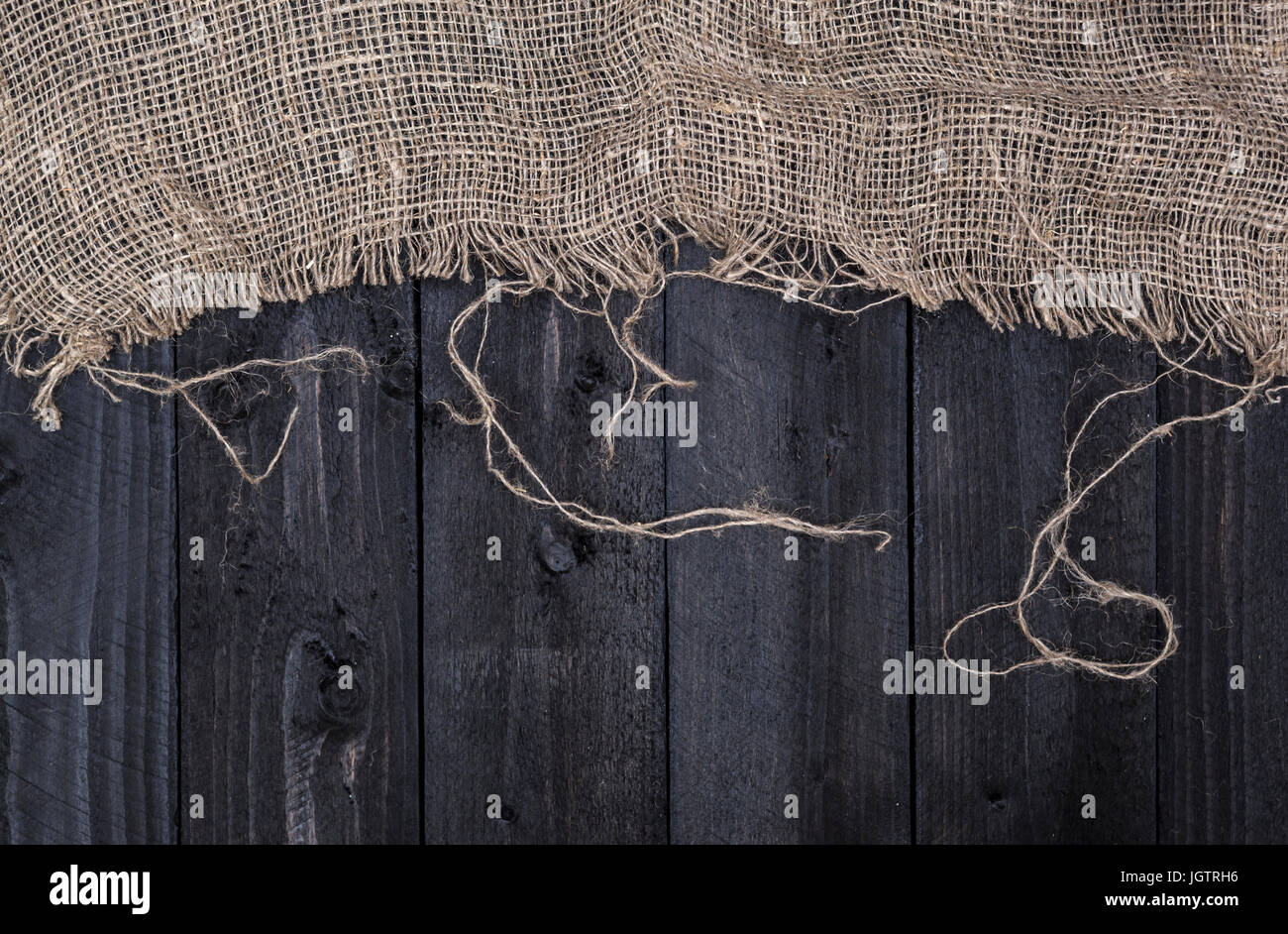 Black wooden table with burlap tablecloth, top view, copy space Stock ...