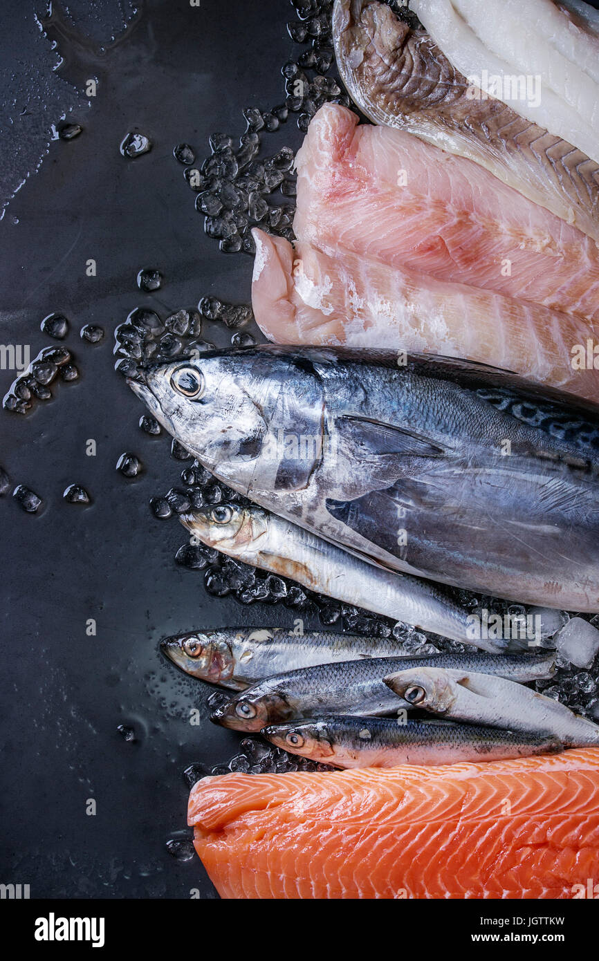 Variety of raw fresh fish. Whole tuna and herring, fillet of salmon ...