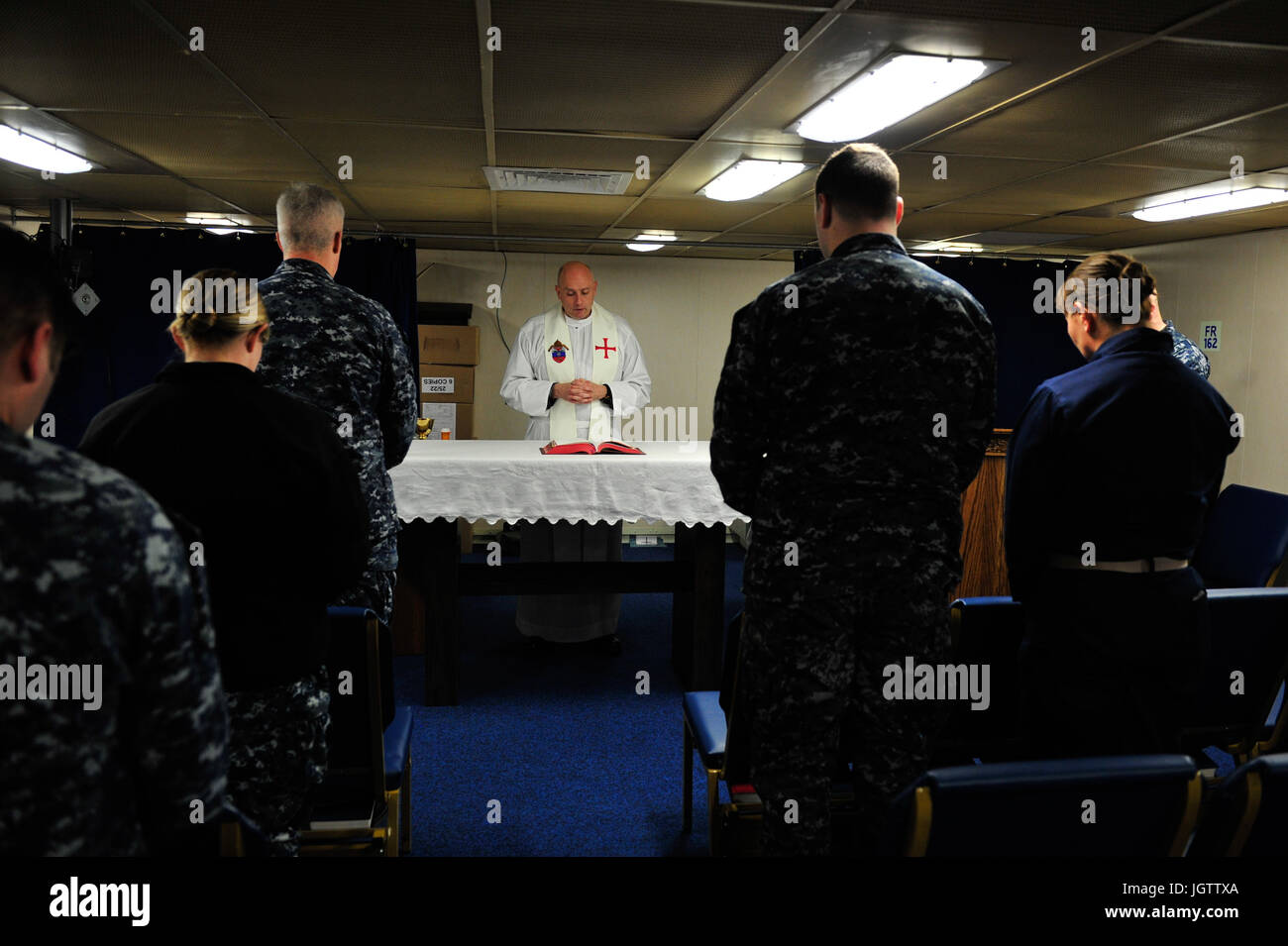 The Command Chaplain aboard USS George H. W. Bush delivers the first ...