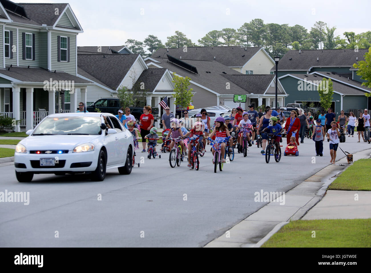 Community members parade through their neighborhood during the first ...