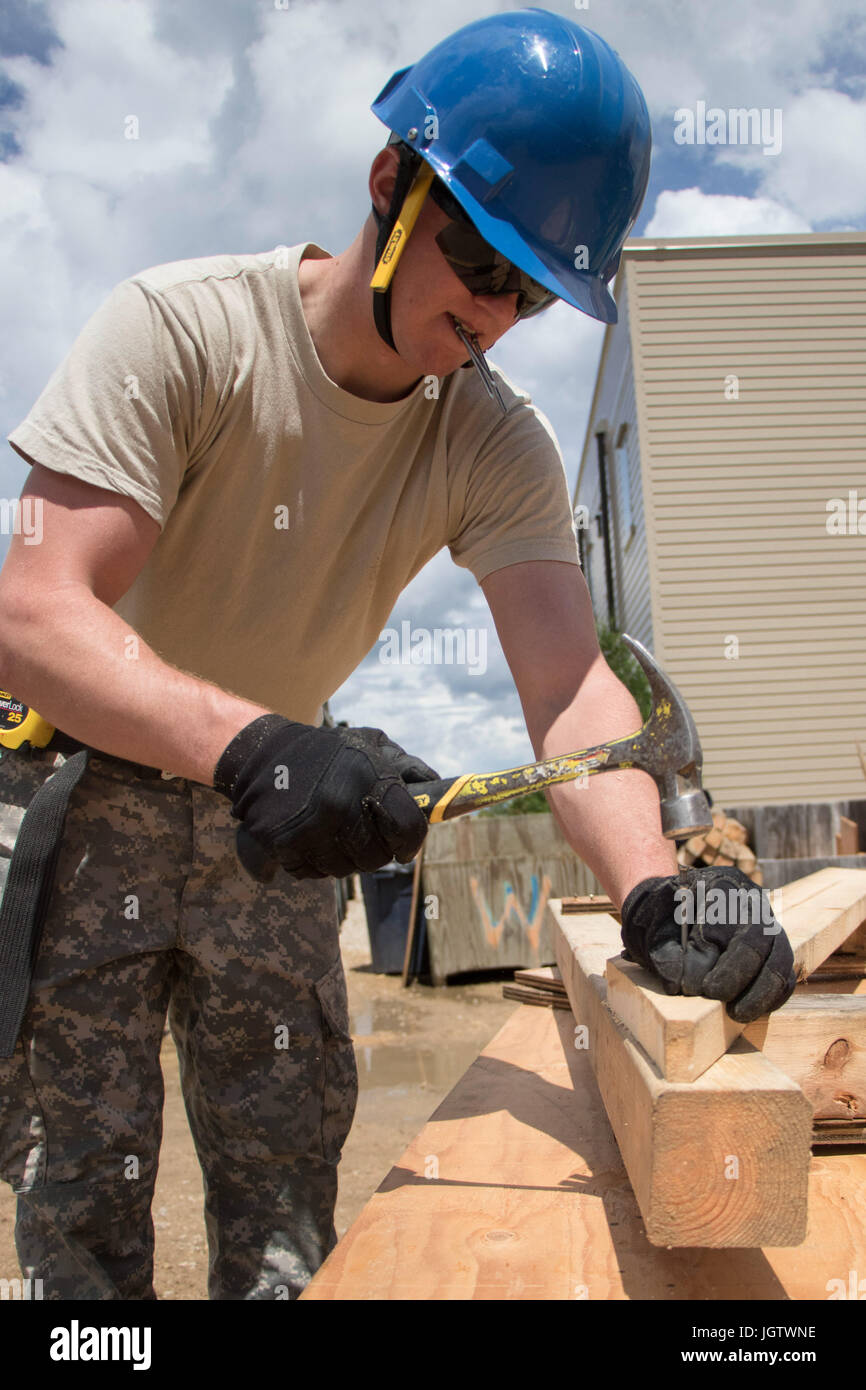 A soldier with the 1049th Firefighting Detachment, nails a diagonal ...