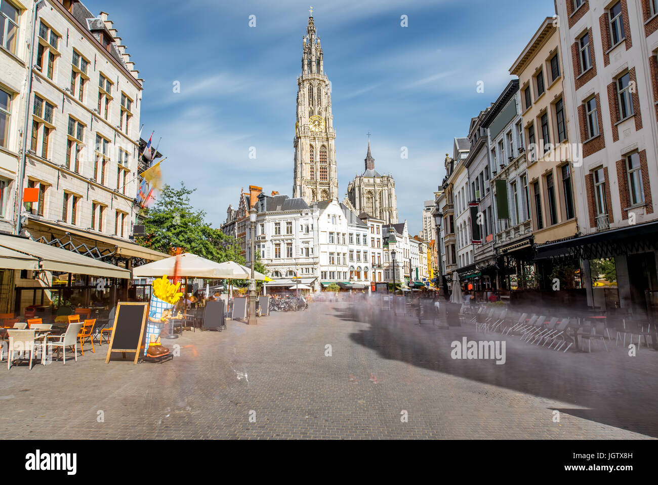 Street view with Our Lady church tower in the center of Antwerpen city ...