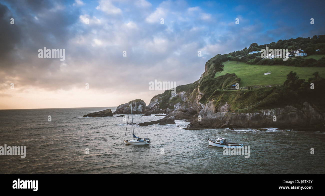 Seaside cliffs with Boats Stock Photo - Alamy