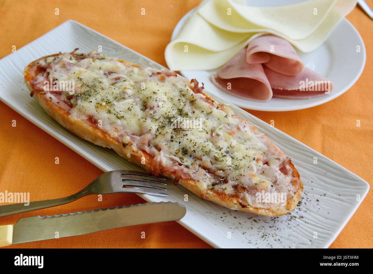 Bread pizza with ham and cheese and dark tea Stock Photo - Alamy